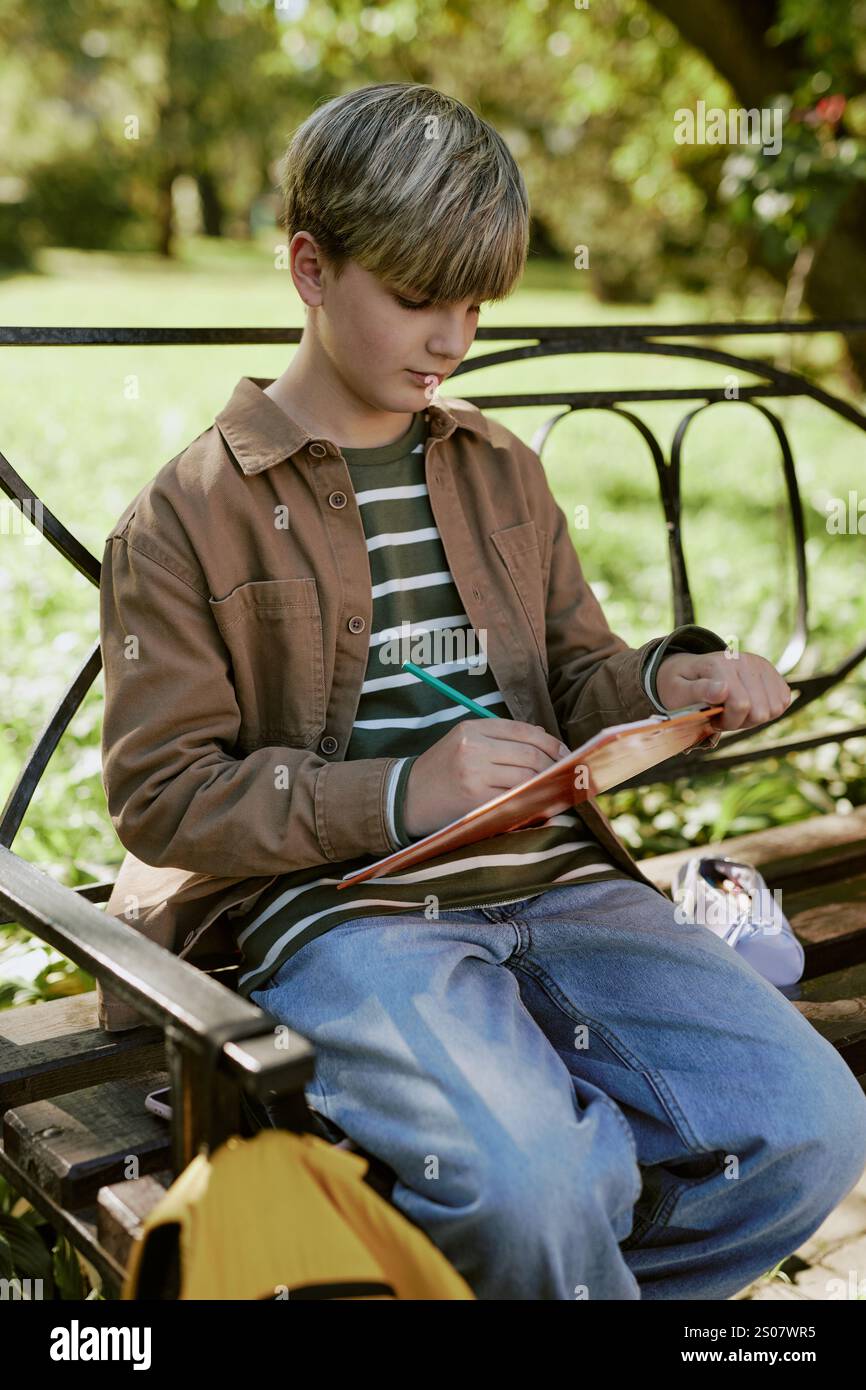 Creative Boy Drawing In Park Stock Photo - Alamy