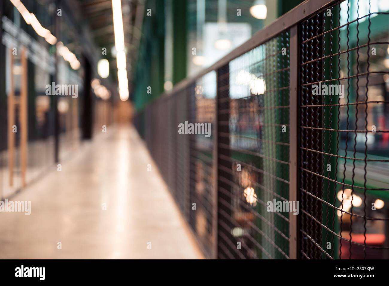 Perspective view of unfocused elevated walkway in loft office building ...