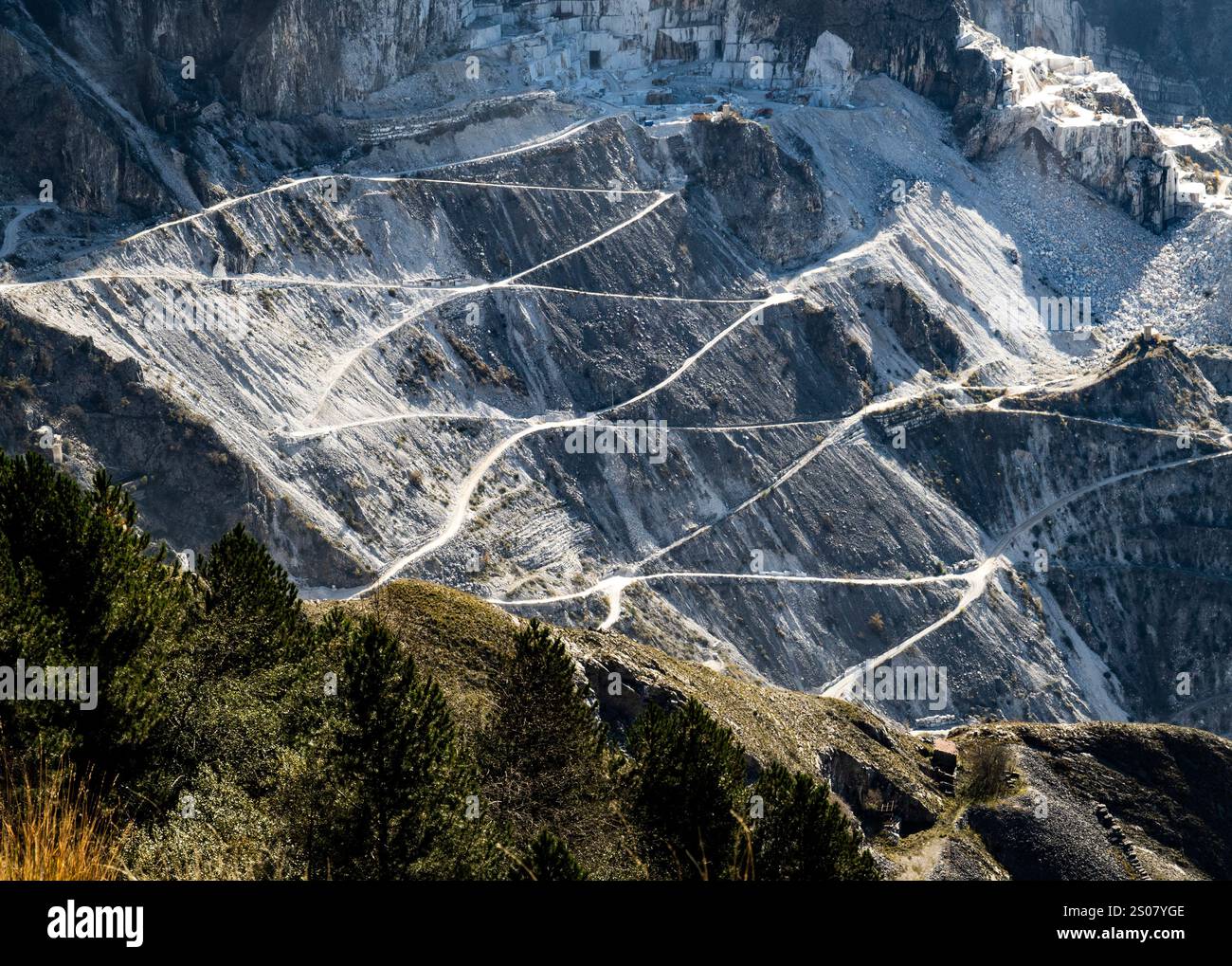 Aerial view of a quarry with winding paths and steep rocky terrain ...