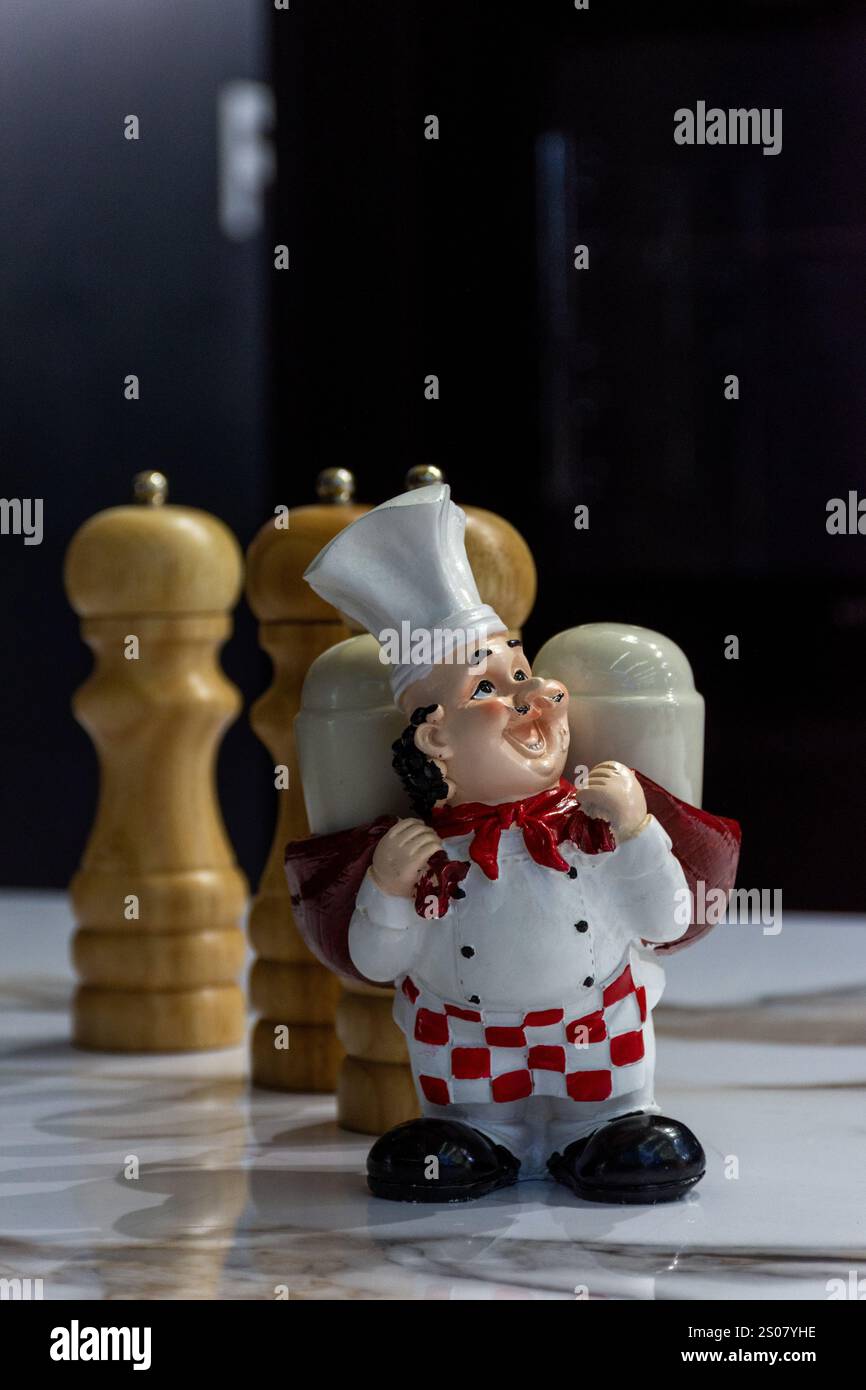 A small statue of a chef wearing a uniform in the kitchen Stock Photo ...