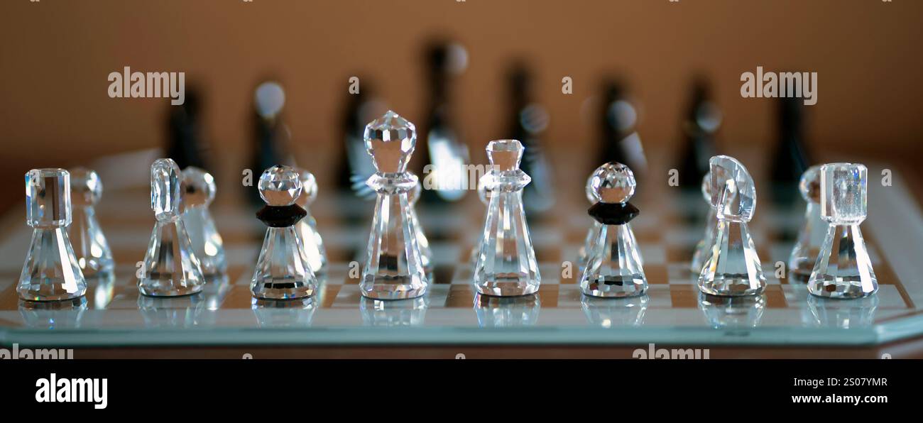 A close-up view of a chessboard featuring elegant crystal chess pieces ...