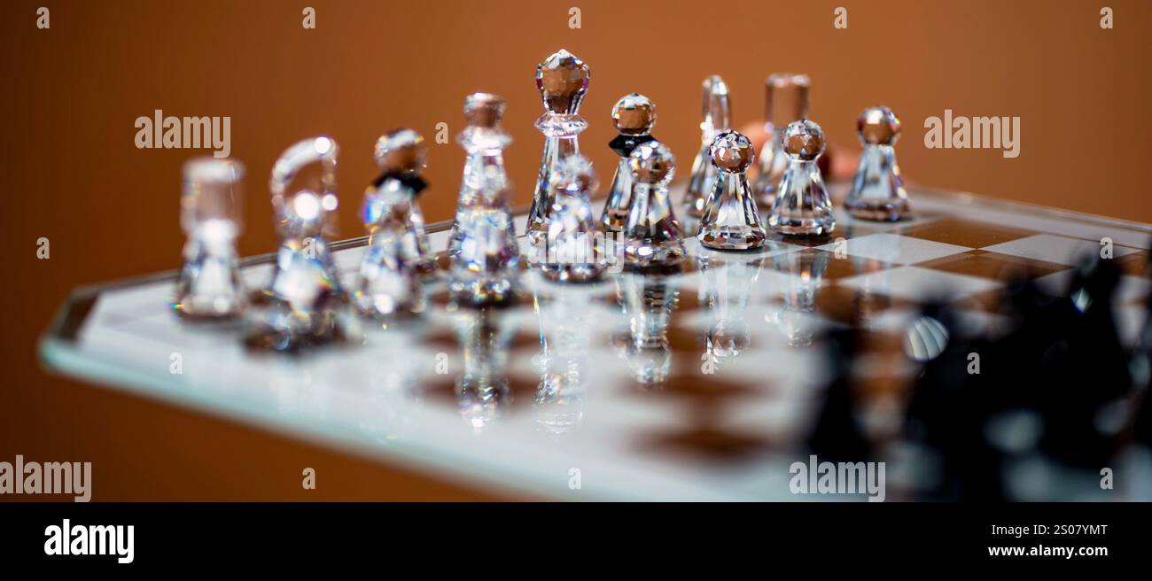 A close-up view of a crystal chess set on a glass board, showcasing the ...