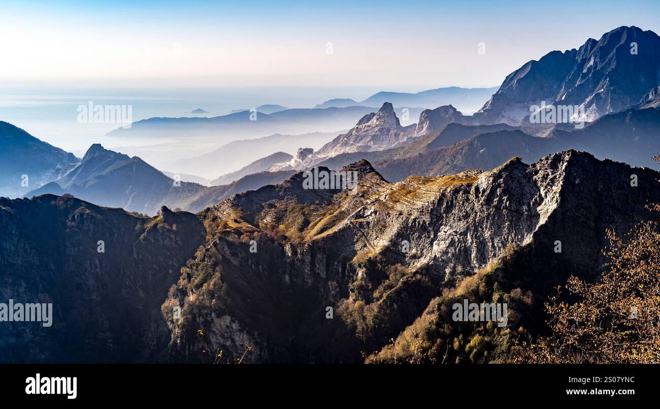 A breathtaking mountain landscape featuring rugged peaks and a misty ...