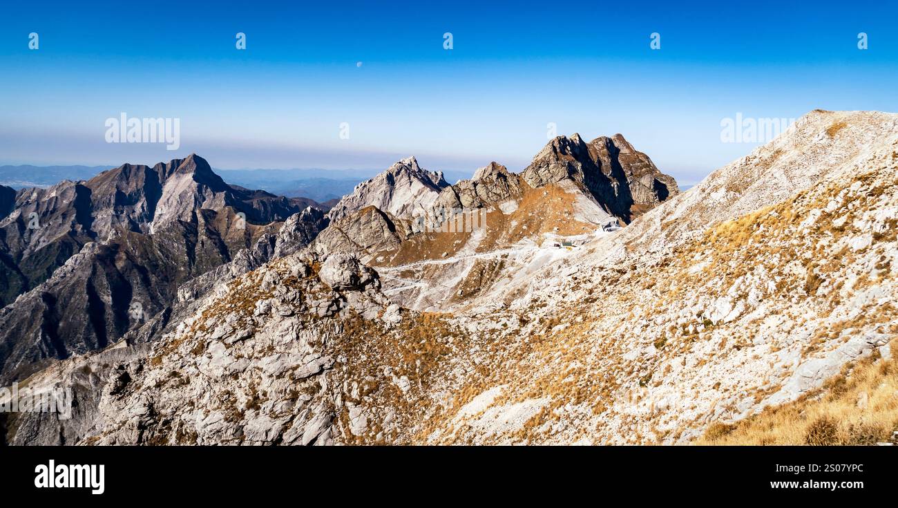 A panoramic view of rugged mountain peaks under a clear blue sky ...