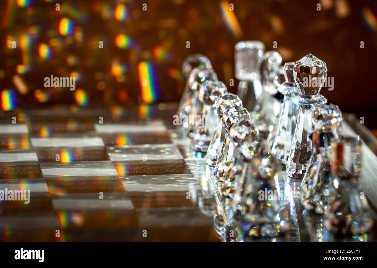 A close-up view of a crystal chess set on a reflective board, with ...