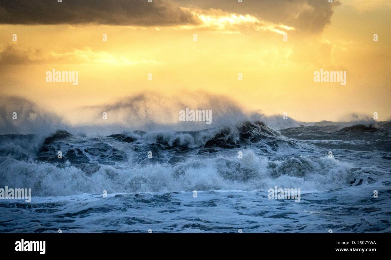 A dramatic seascape featuring turbulent waves crashing against each ...