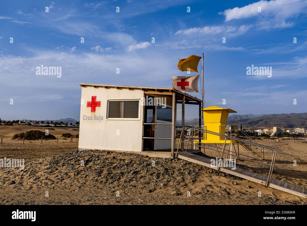Scenic view of an iconic yellow lifeguard tower with yellow flag on ...