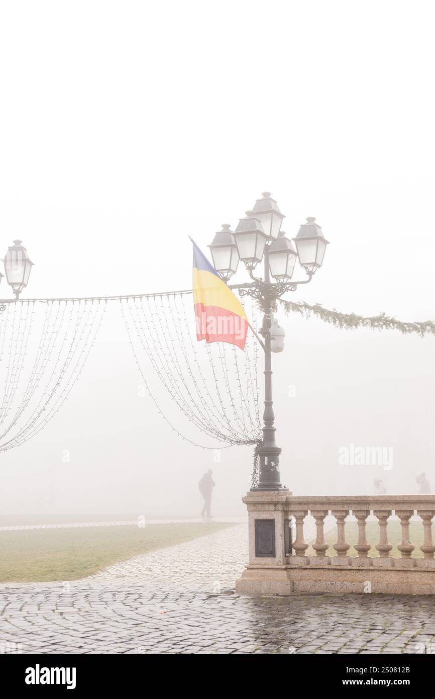 A wrought-iron streetlamp, adorned with festive lights, holds the ...