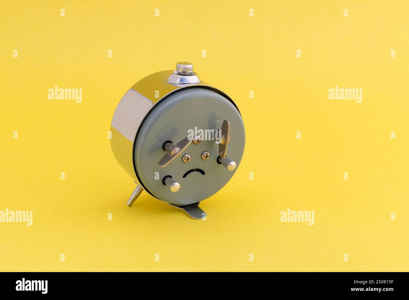 Backside of mechanical vintage alarm clock with Key for winding up the ...