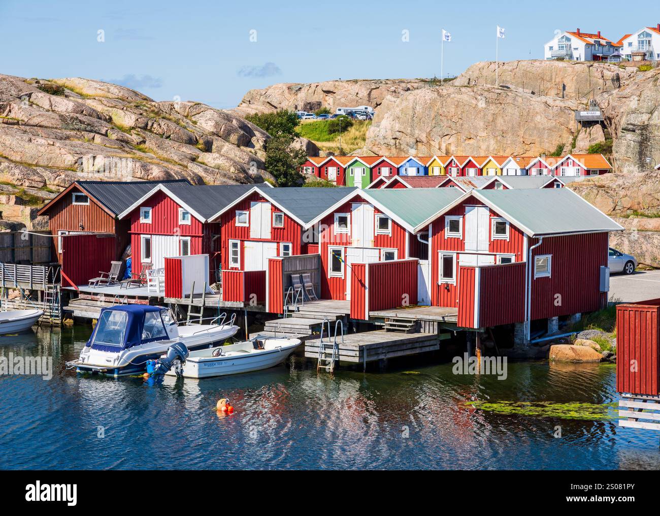 Two rows of multicolored wooden houses in Smögen, Sweden, lined up ...