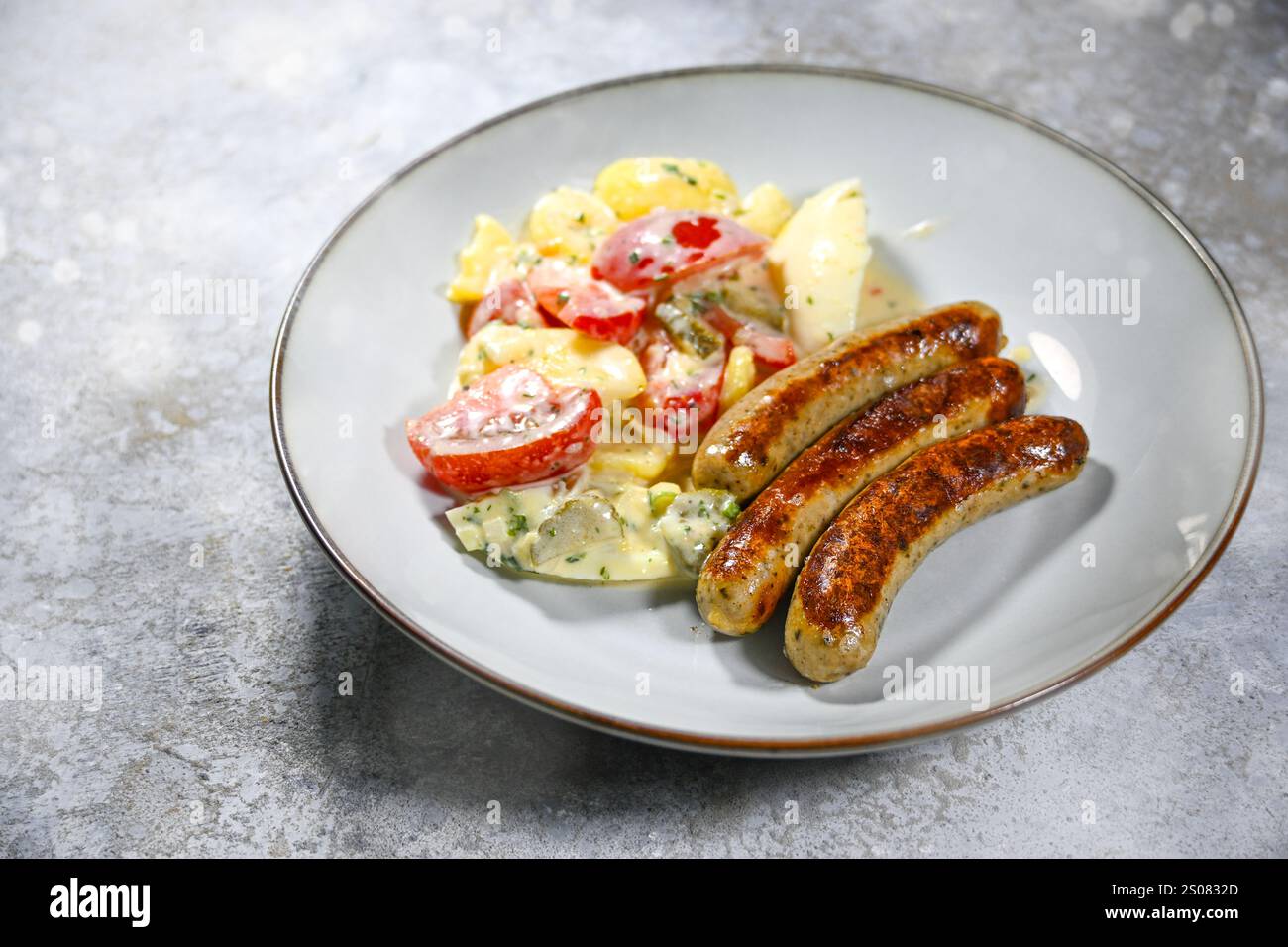 Potato salad with small roasted sausages, a popular fast dish for ...