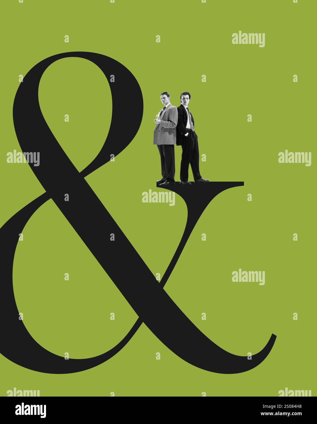 Two businessmen stand confidently on large ampersand symbol ...