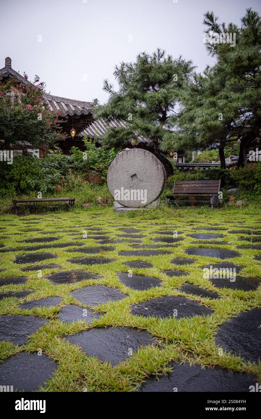 Green moss-covered stone plaza and park bench located in Jeonju, South ...