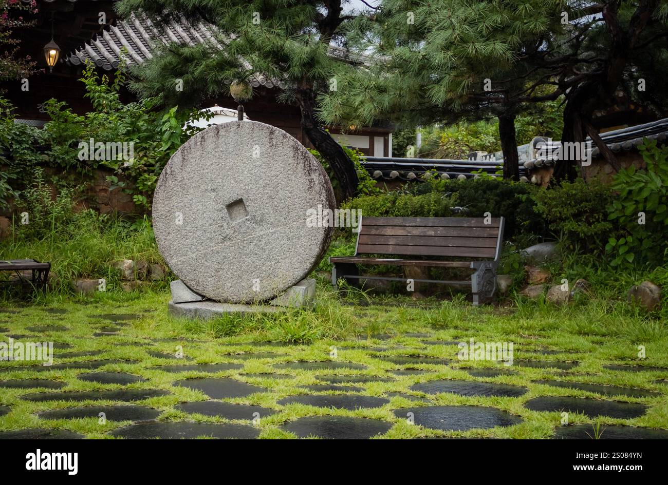 Green moss-covered stone plaza and park bench located in Jeonju, South ...