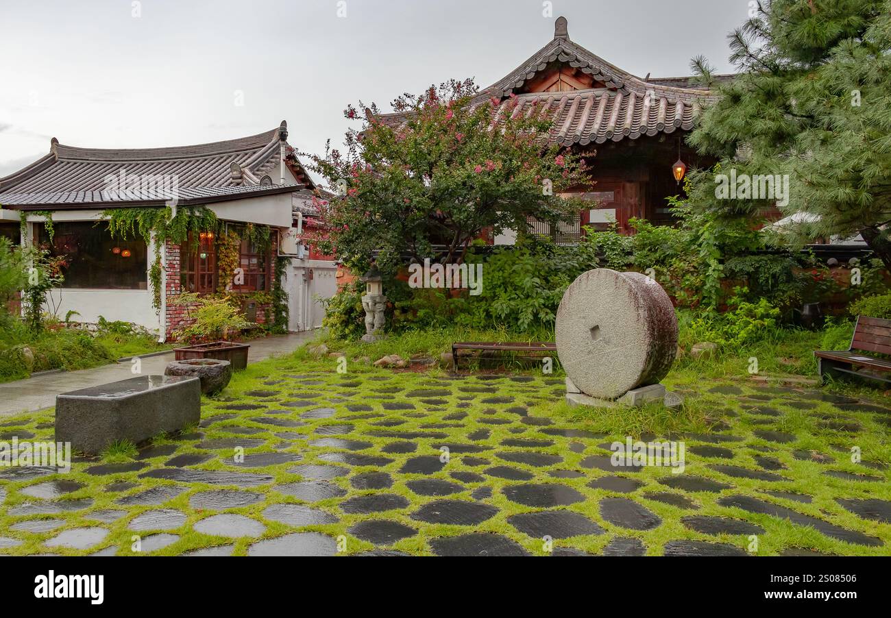 Green moss-covered stone plaza and park bench located in Jeonju, South ...