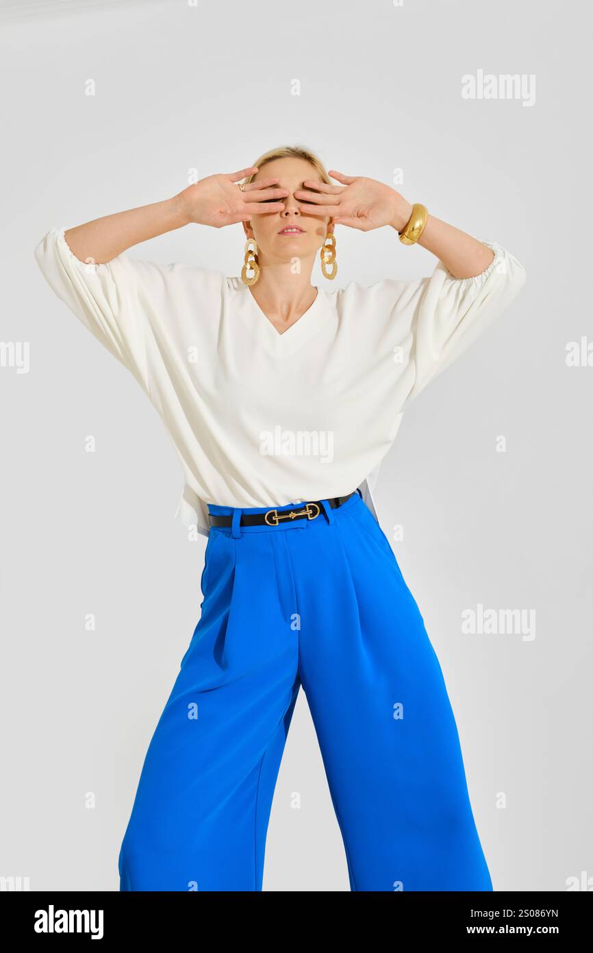 A model stands confidently in a minimalist studio, striking a pose ...