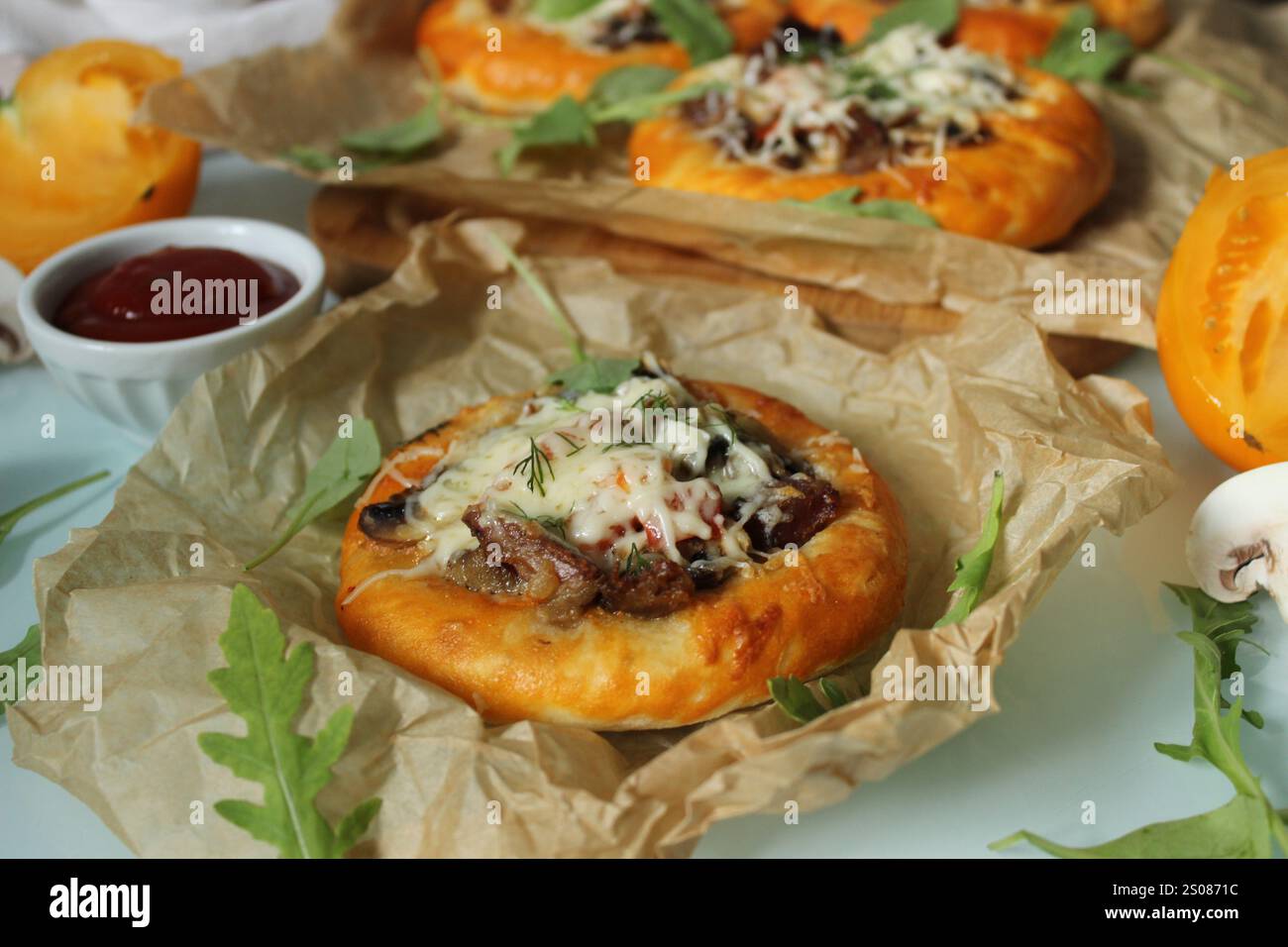 Savory mini pizza topped with melted cheese, mushrooms, and fresh ...