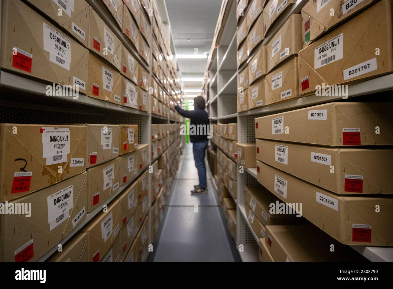 Rows of shelves containing archive boxes of records closed at the ...