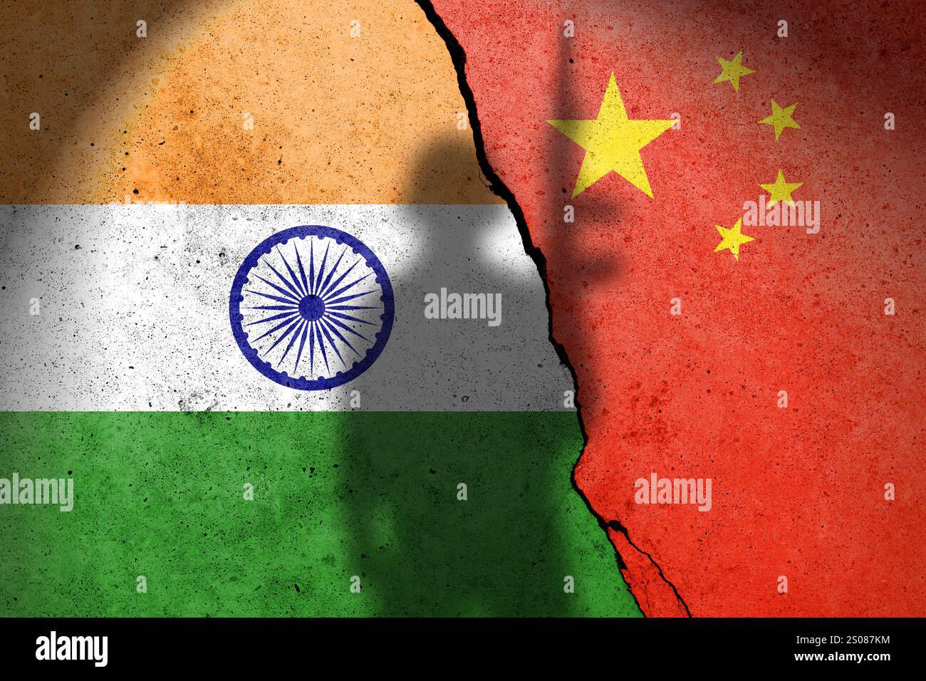Flag of India and China painted on a concrete wall with soldier shadow ...