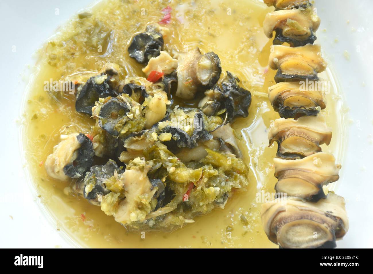 baking cherry or golden apple snail stabbing wooden stick dressing Thai ...