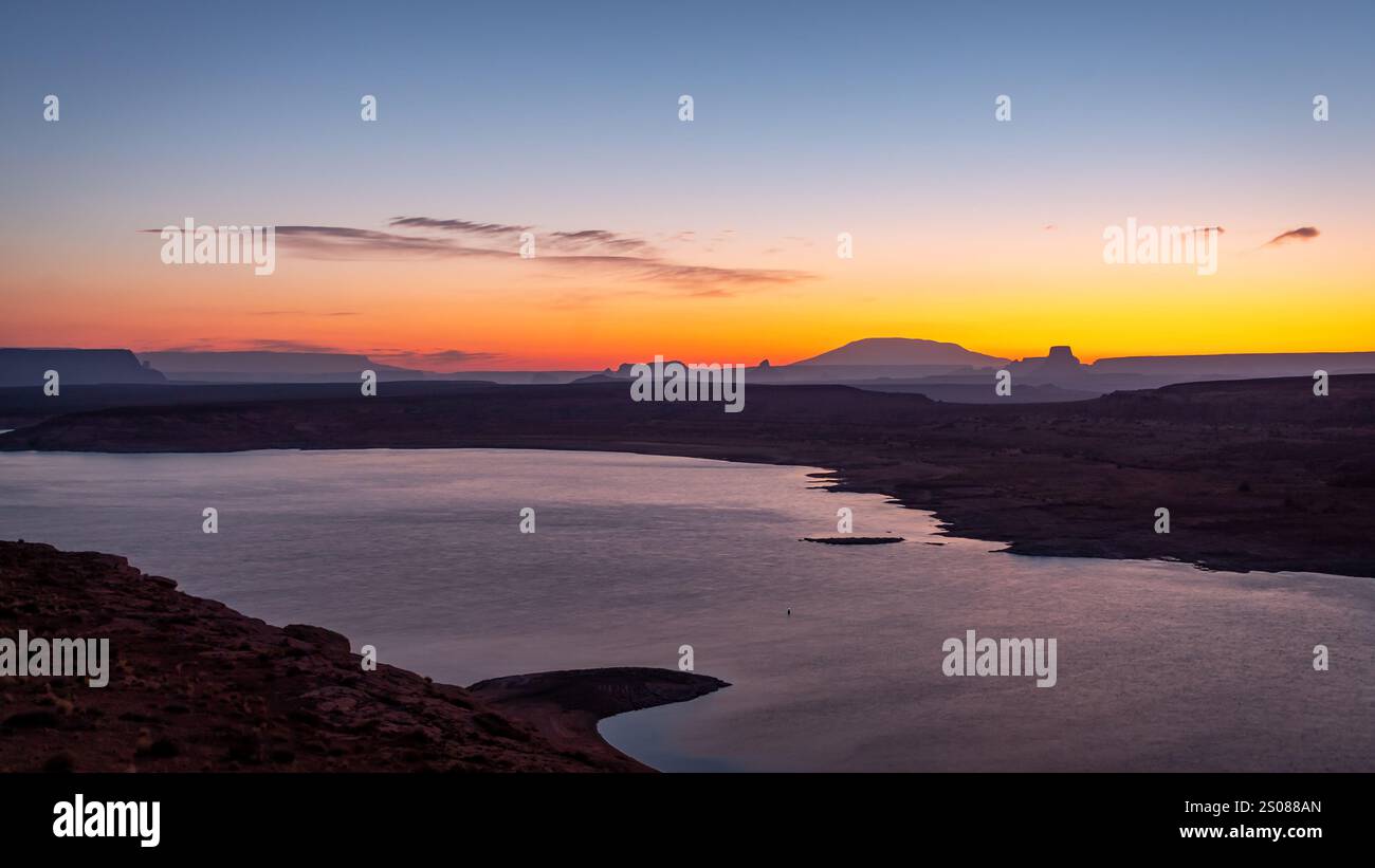 Morning golden sunrise over the rocky desert mountains of Lake Powell ...