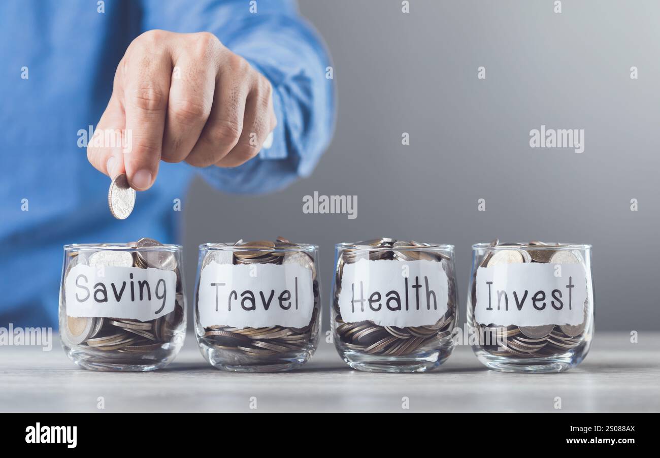 A man dropping a coin into a glass jar labeled Saving, The concept of ...