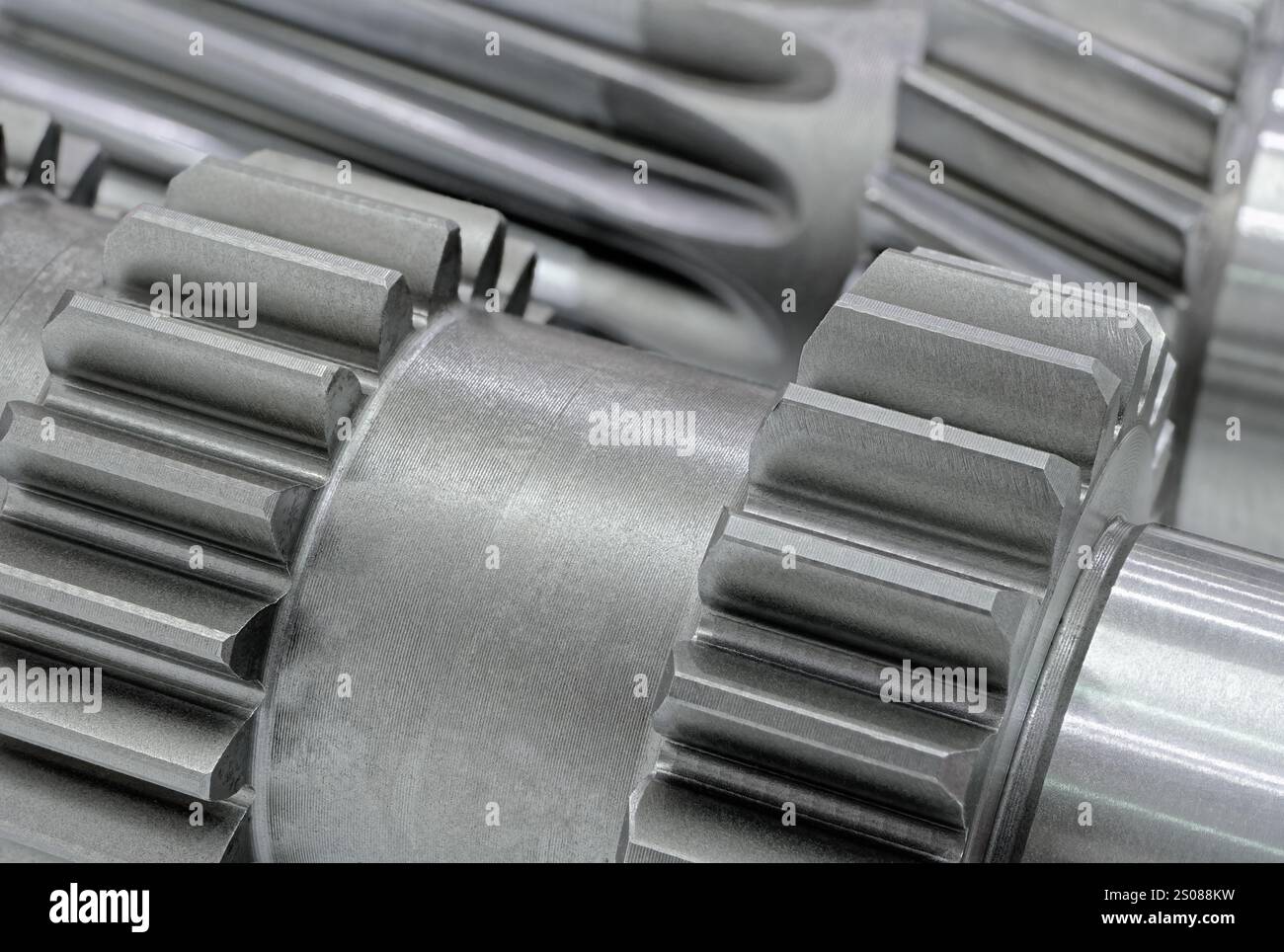 Assorted steel gearwheels and shafts, parts of gear transmission, close ...