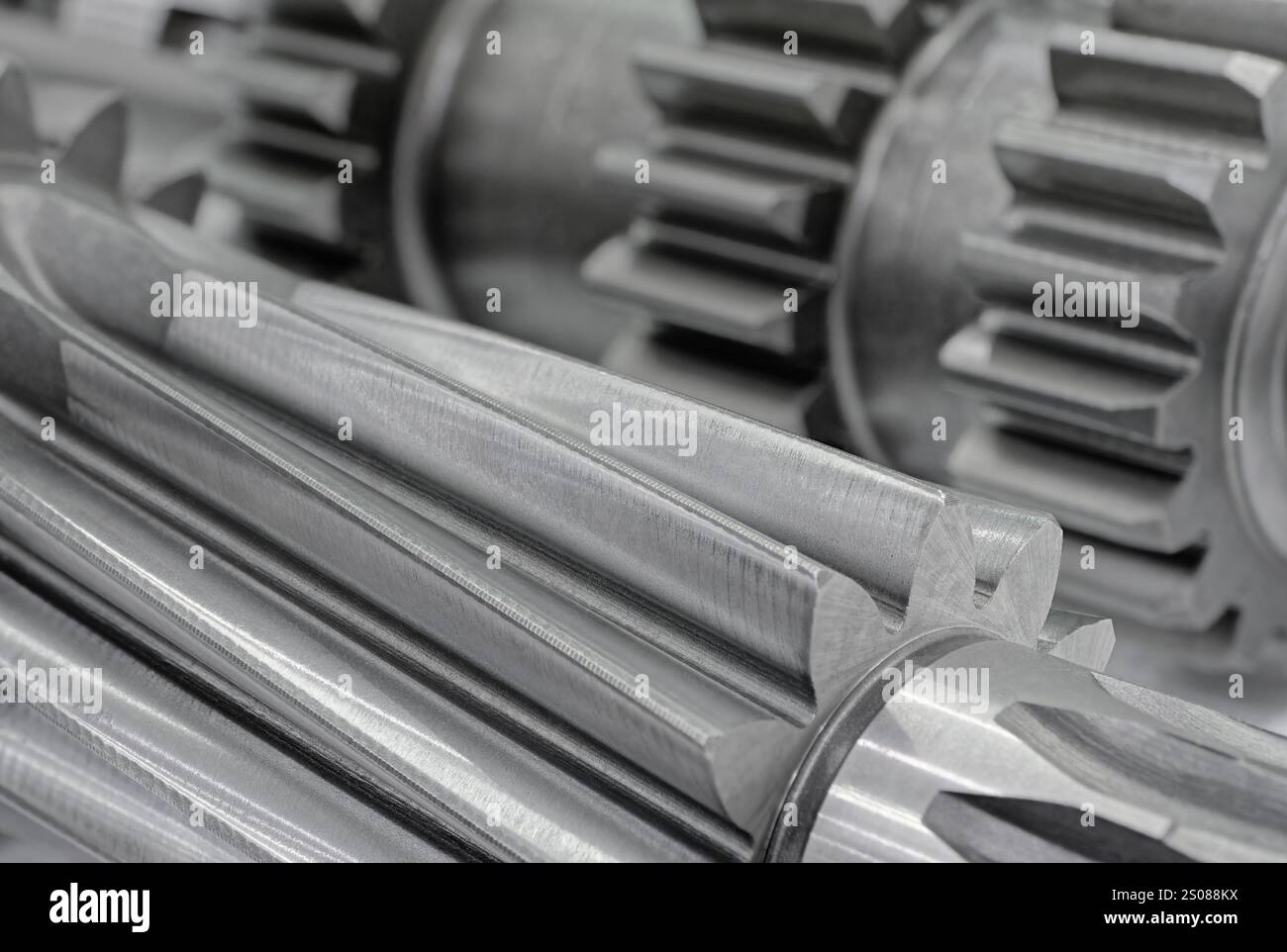 Assorted steel gearwheels and shafts, parts of gear transmission, close ...