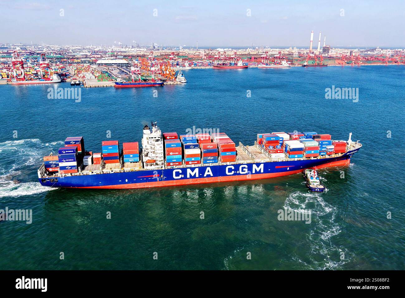 A CMA CGM container ship sails in a port in Qingdao in east China's ...