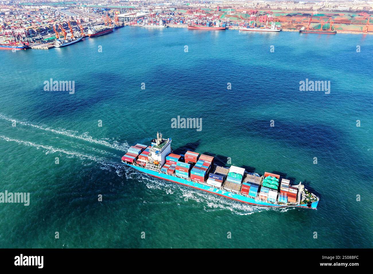 An SITC container ship sails in a port in Qingdao in east China's ...