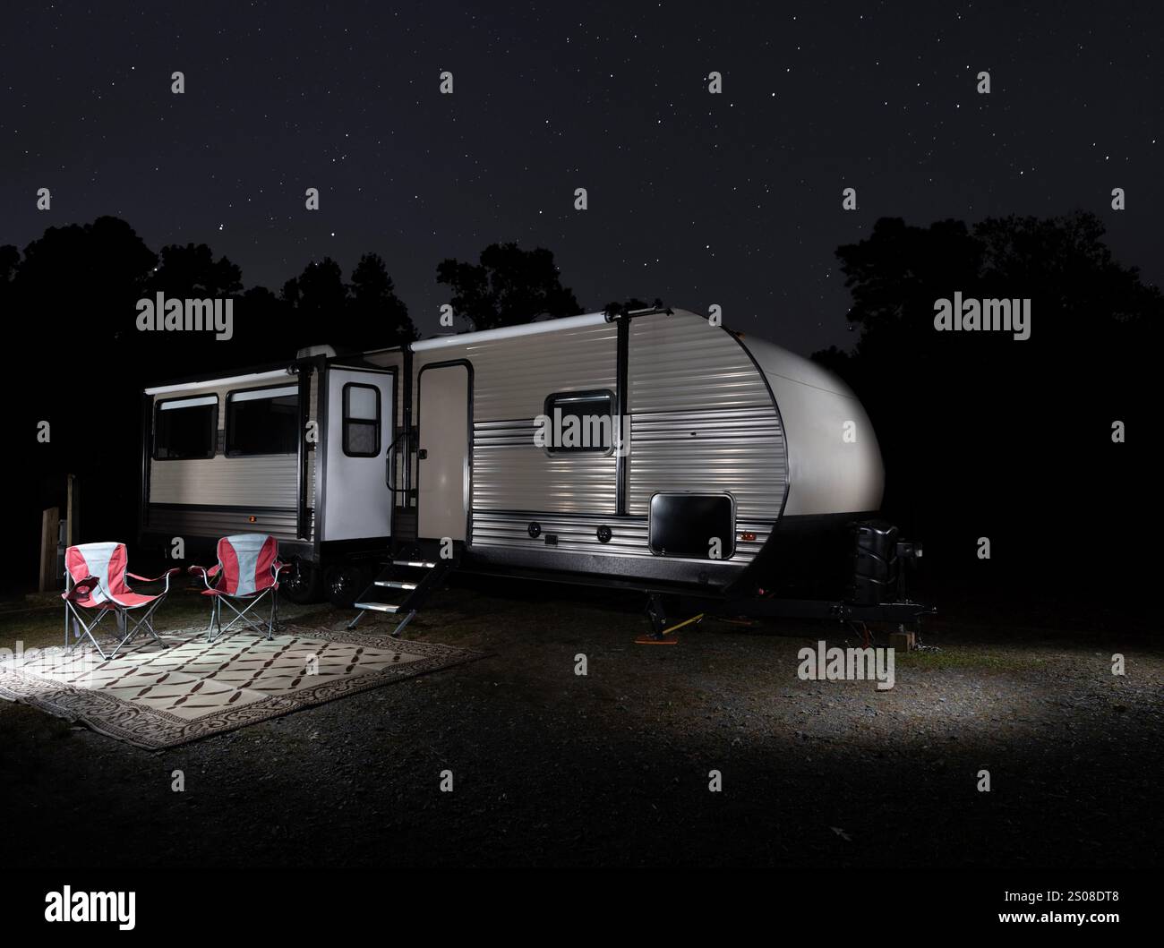 Night sky with stars over a campsite with a camper trailer Stock Photo ...
