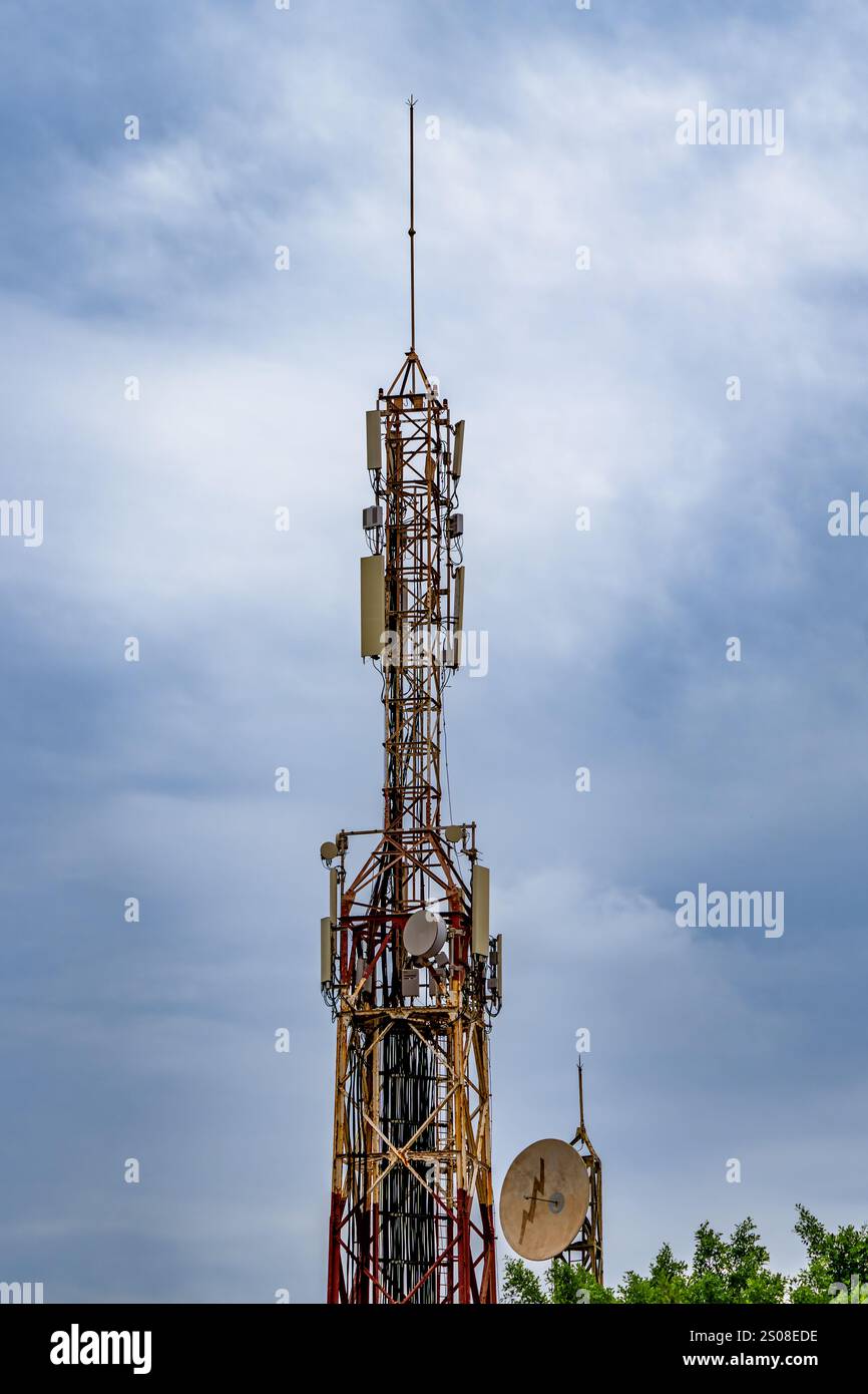 Communication tower with blue sky and clouds moving background. View of ...