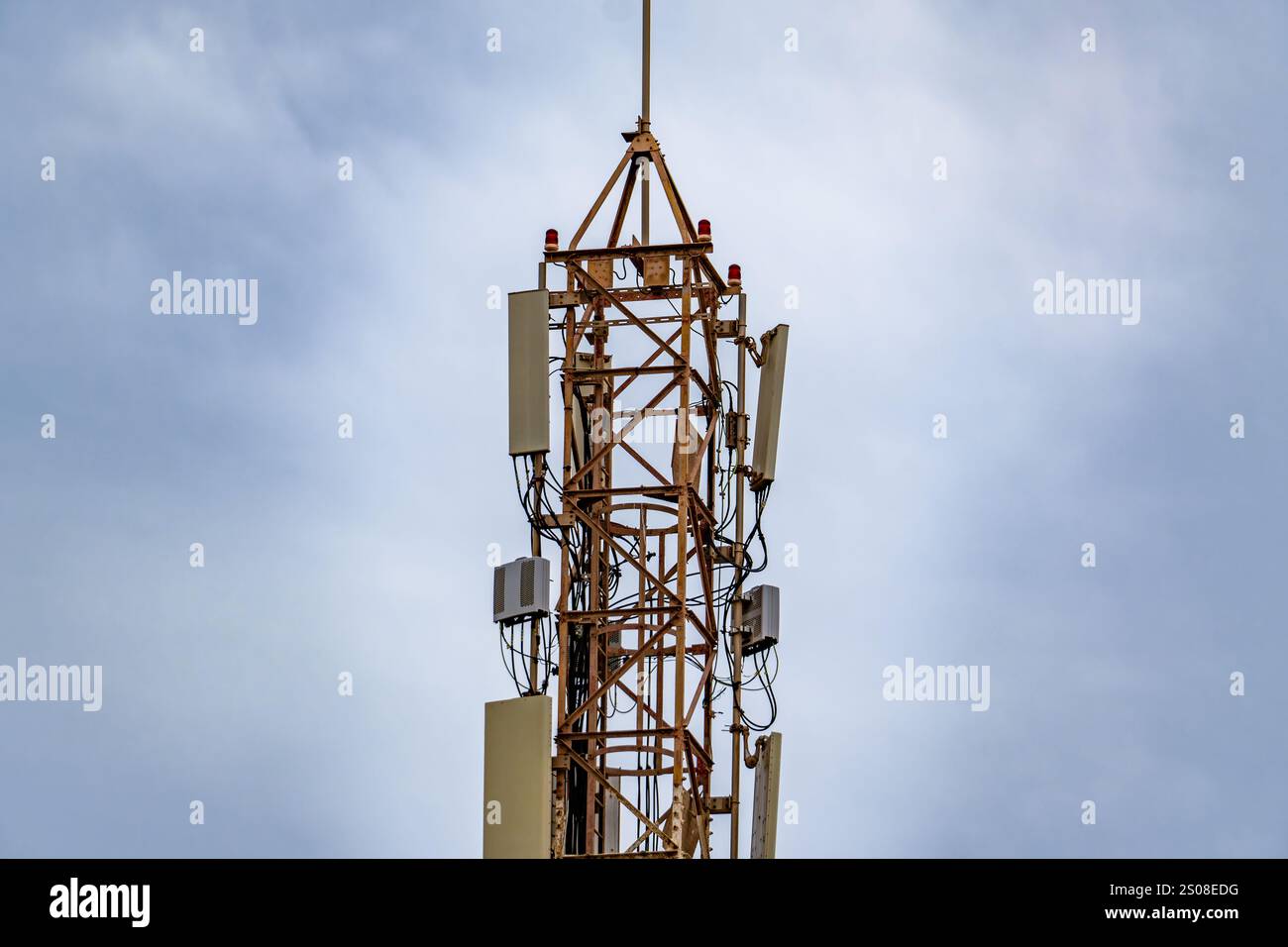 Communication tower with blue sky and clouds moving background. View of ...