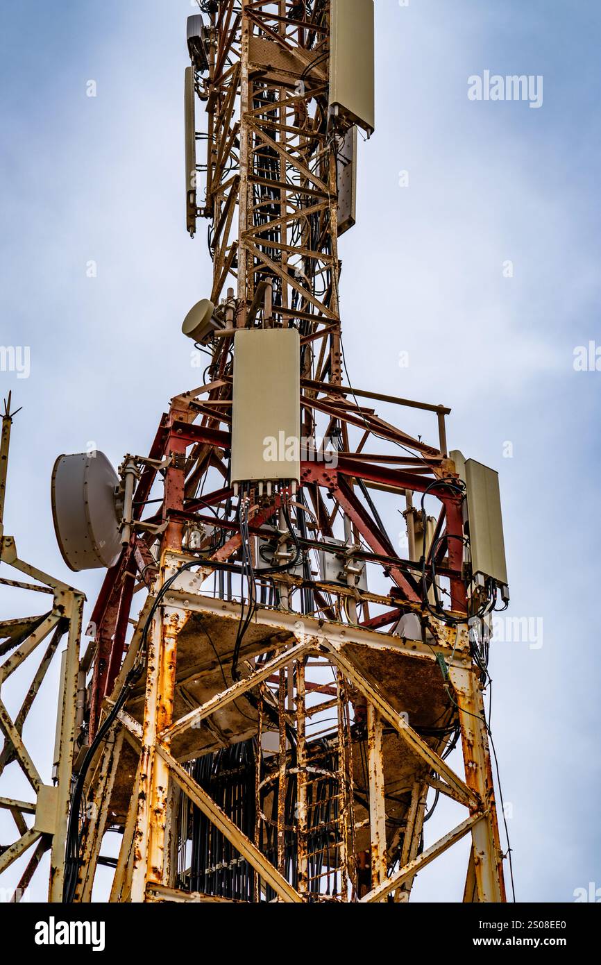 Communication tower with blue sky and clouds moving background. View of ...