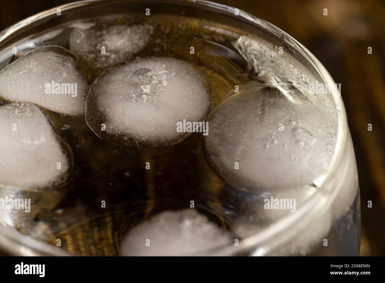 a glass with ice and cold sparkling water, cold mineral water with a lot of gases and bubbles ...