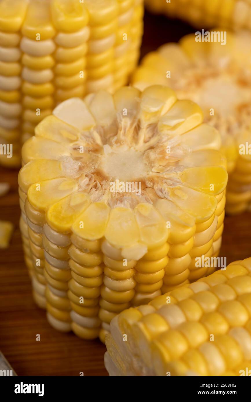 sliced corn cob with yellow and white seeds of different sizes and ...