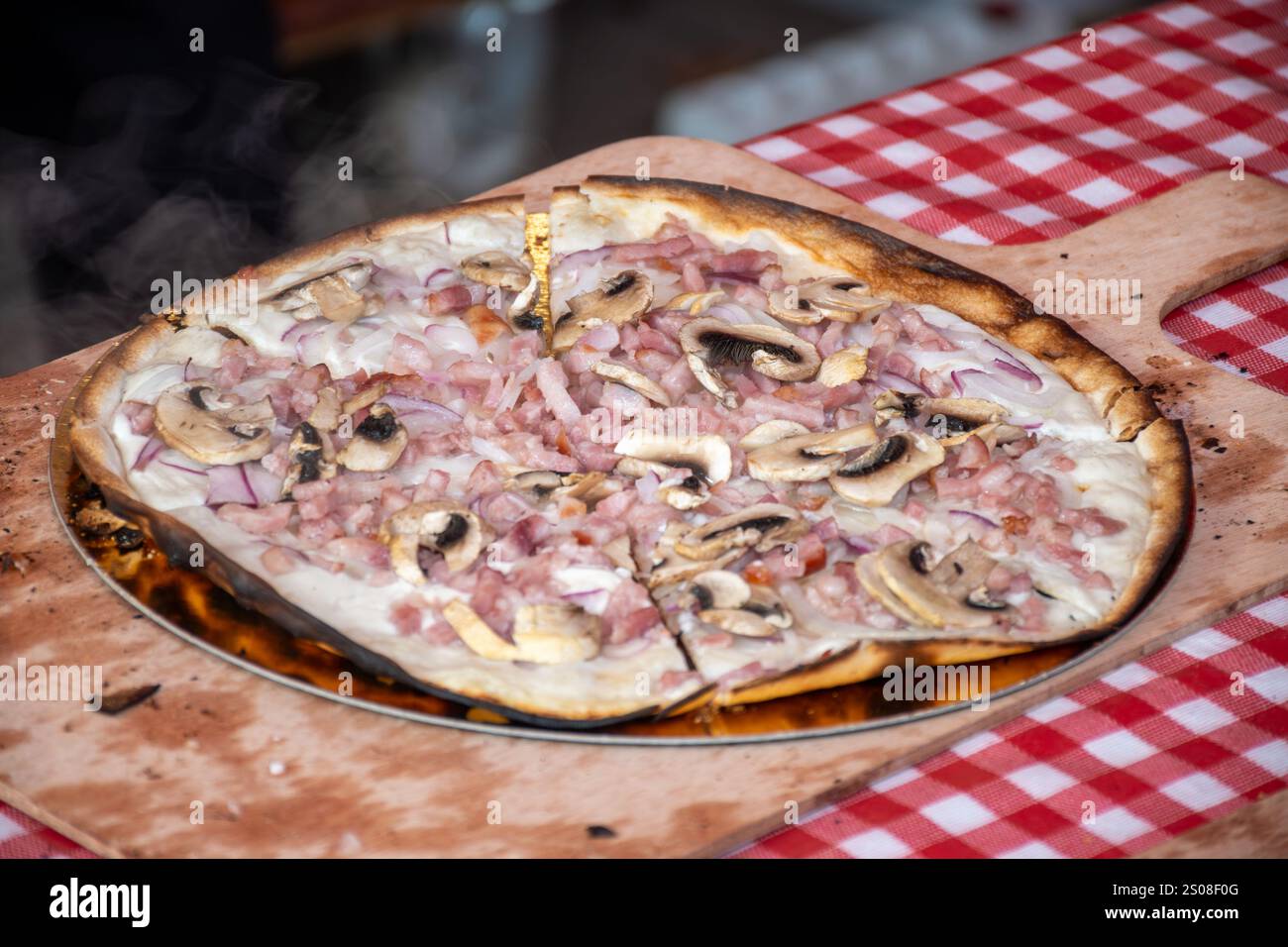 Traditional food of Alsace, flammekuche wood oven baked tarte with ...