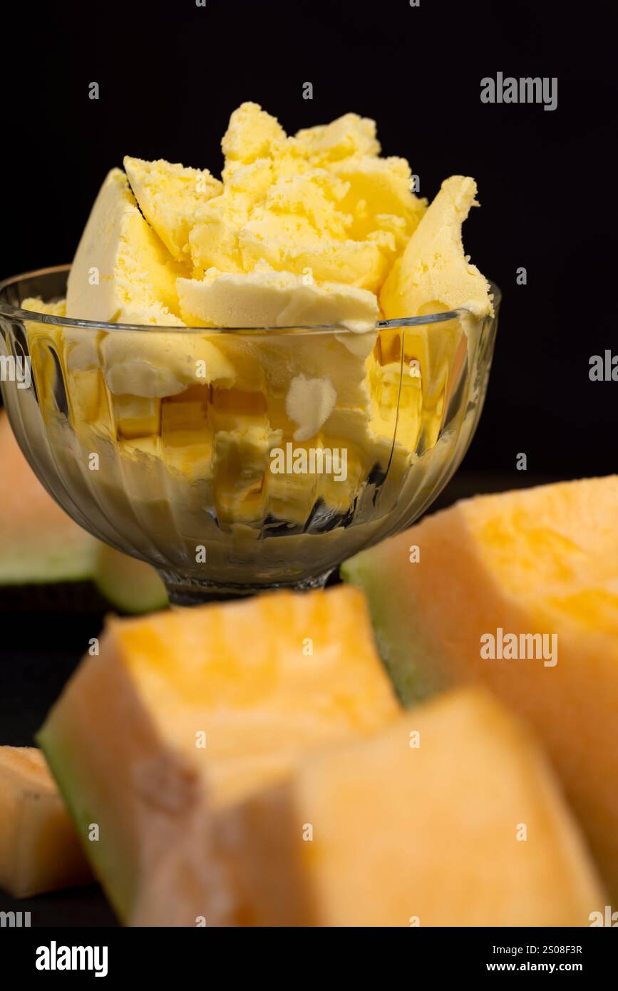 melon flavored ice cream and melon cut into pieces close up, sweet ...