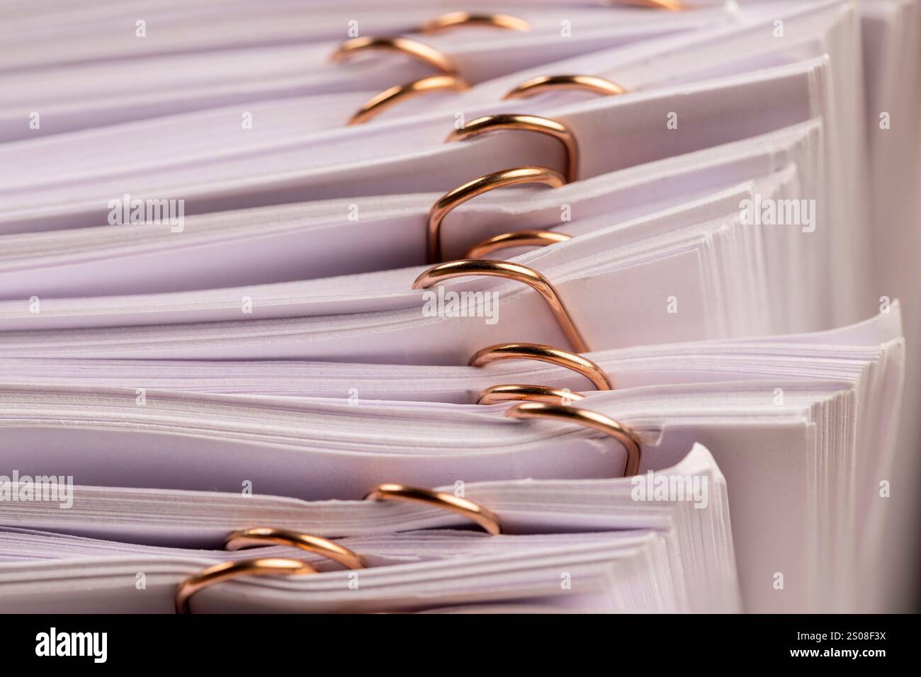 white blank sheets of paper connected by copper staples, a close-up of ...