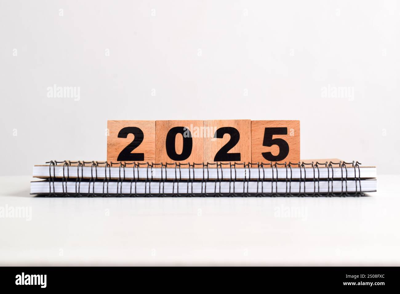 Planning 2025 trends new year symbol. 2025 Concept on wooden blocks and books on white ...