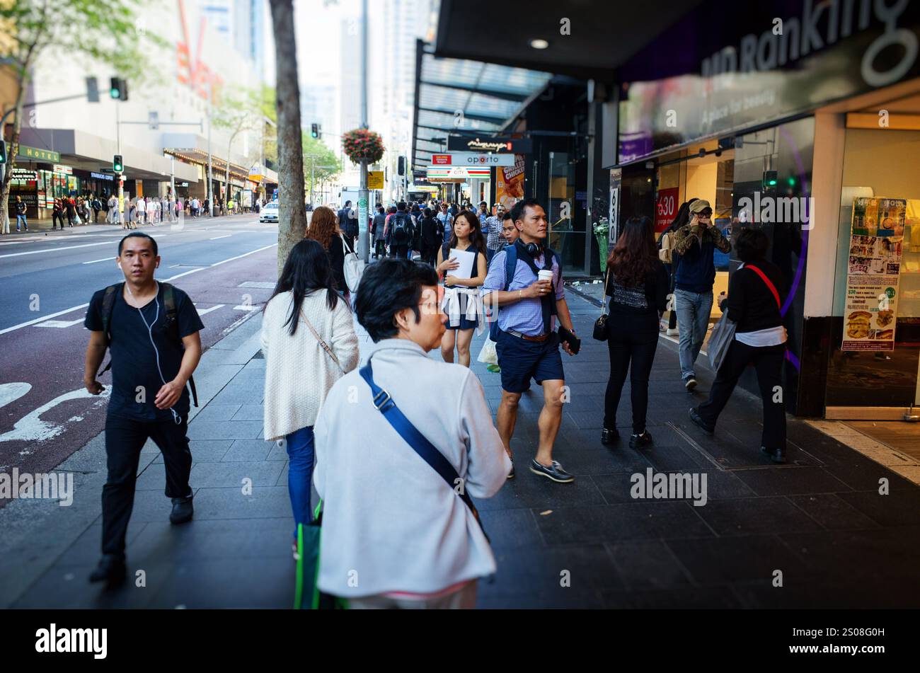 Editorial image of a busy sidewalk on George Street, Sydney. A diverse ...