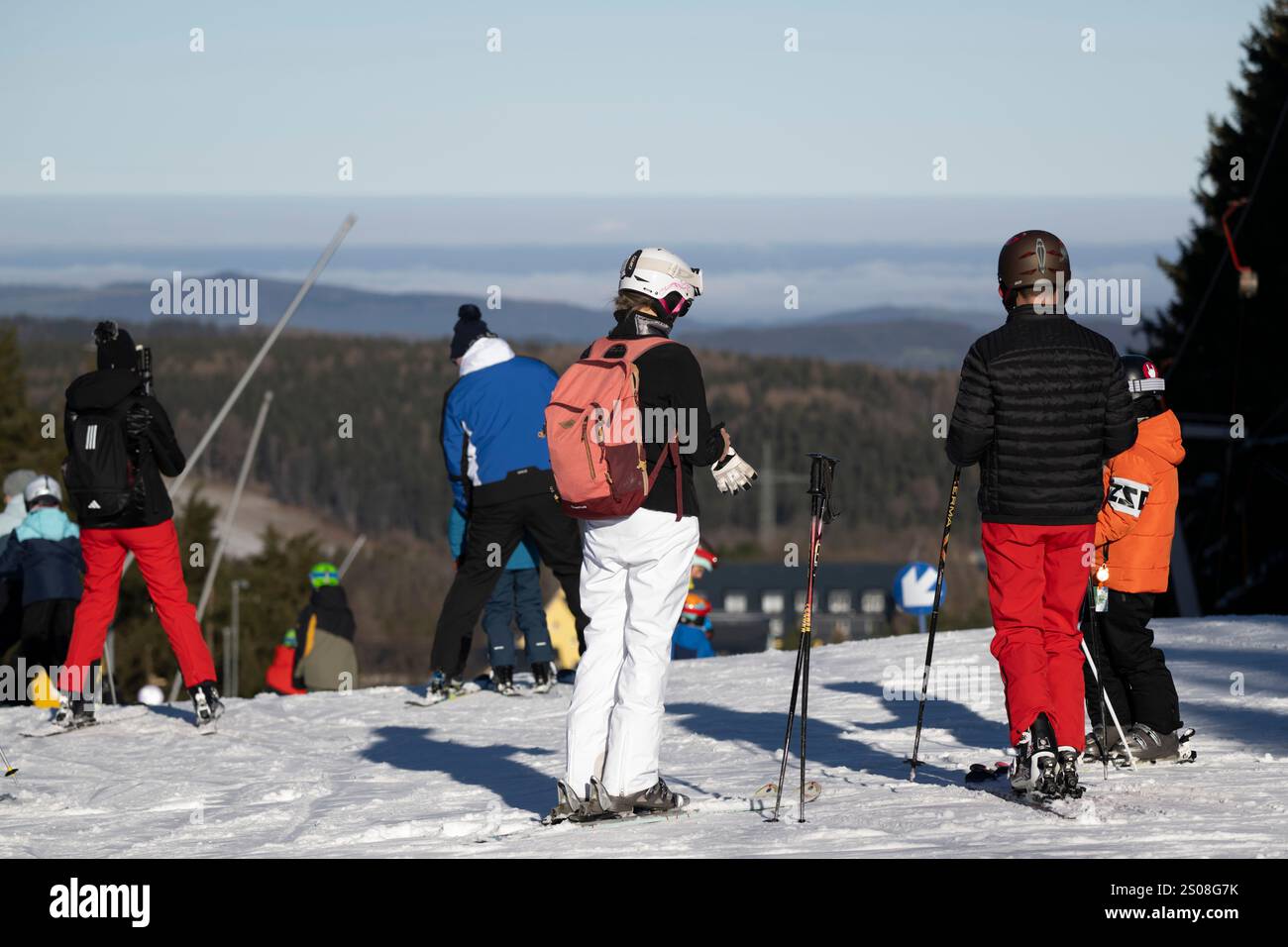 26 December 2024, Saxony, Altenberg: Winter sports enthusiasts stand ...