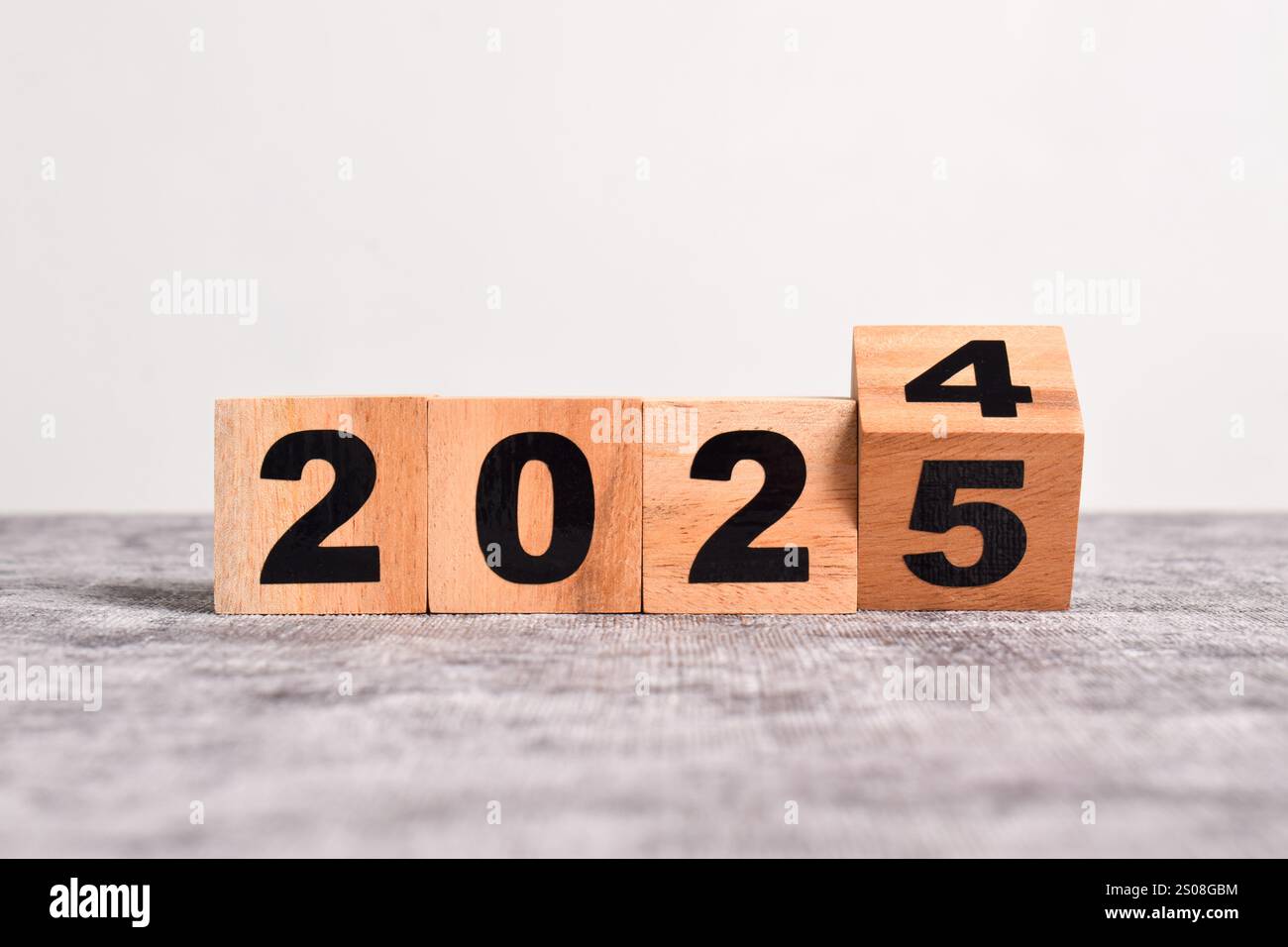 2025 Happy New Year. Wooden cube block change from 2024 to 2025 ...
