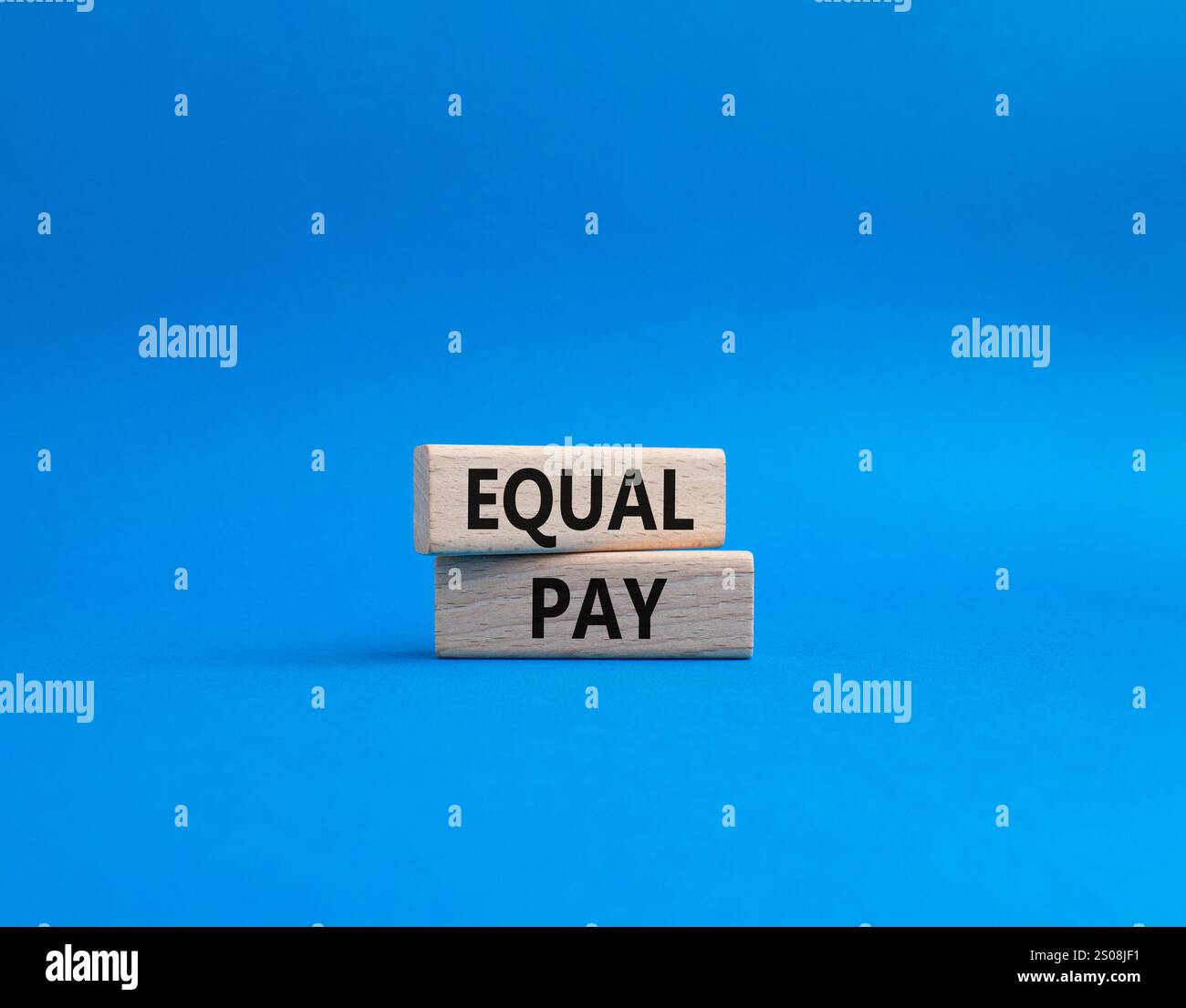 Equal Pay symbol. Wooden blocks with words Equal Pay. Beautiful blue ...