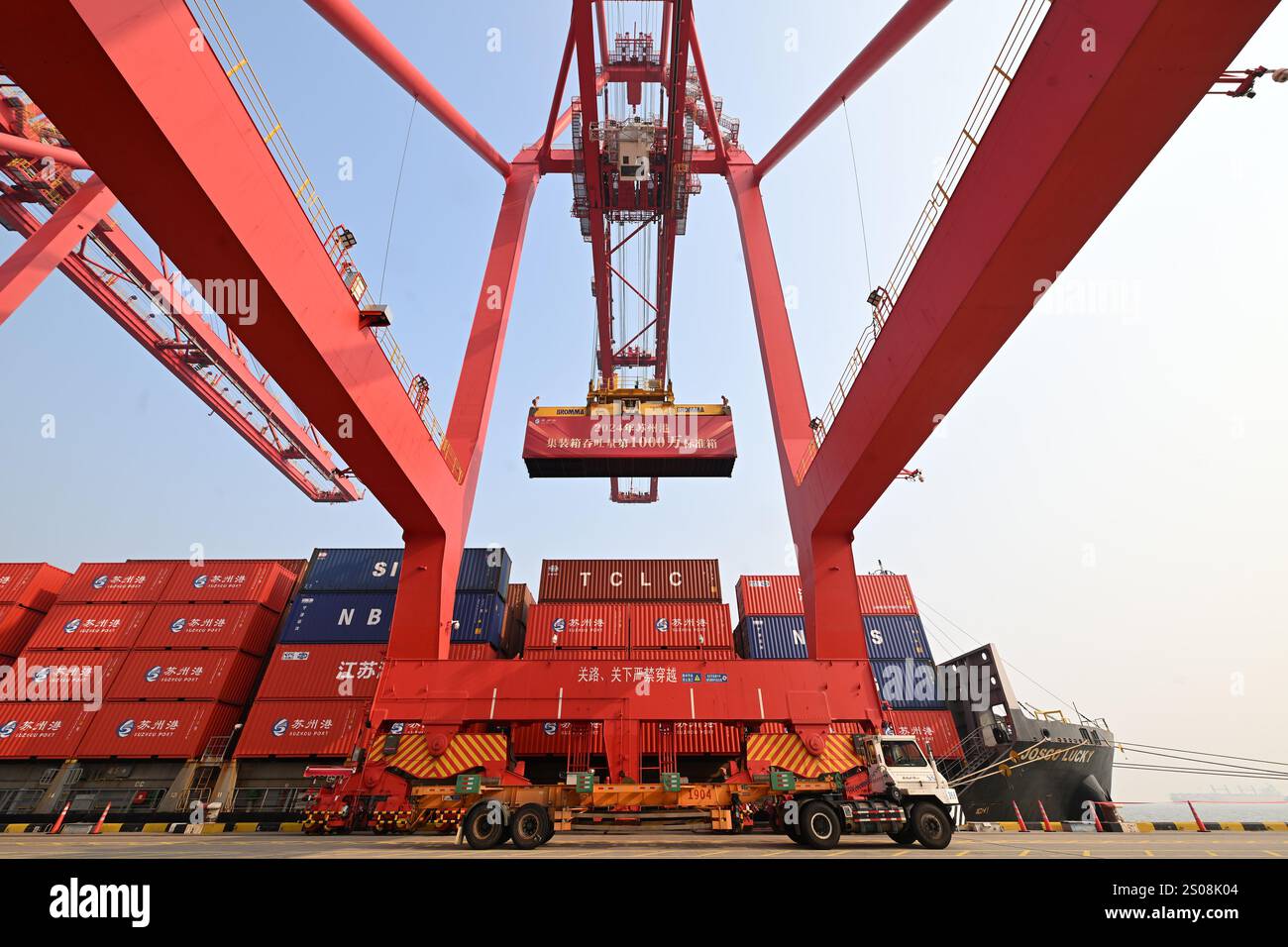 SUZHOU, CHINA - DECEMBER 26, 2024 - A container is lifted to be loaded ...