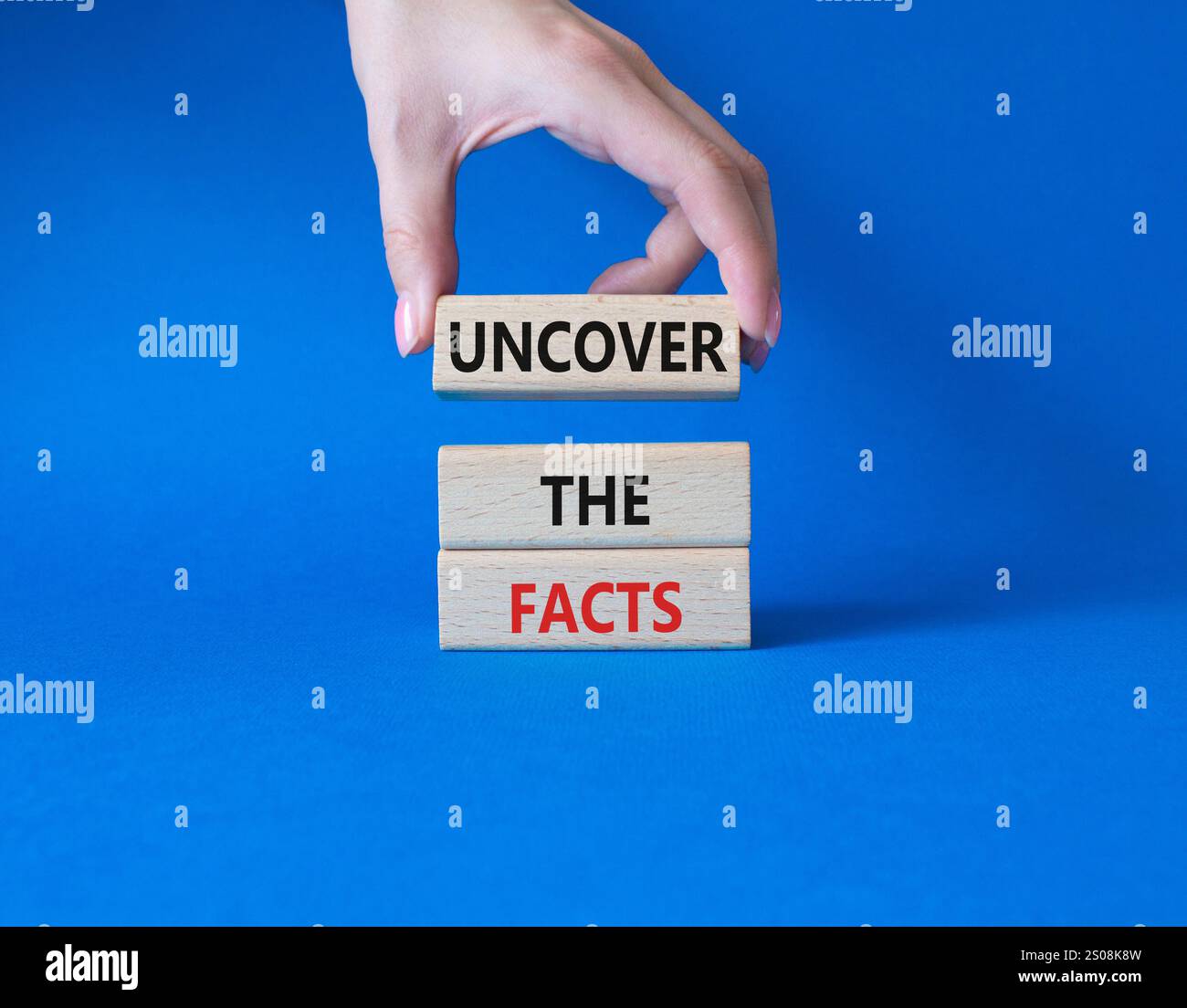 Uncover the Facts symbol. Concept word Uncover the Facts on wooden ...