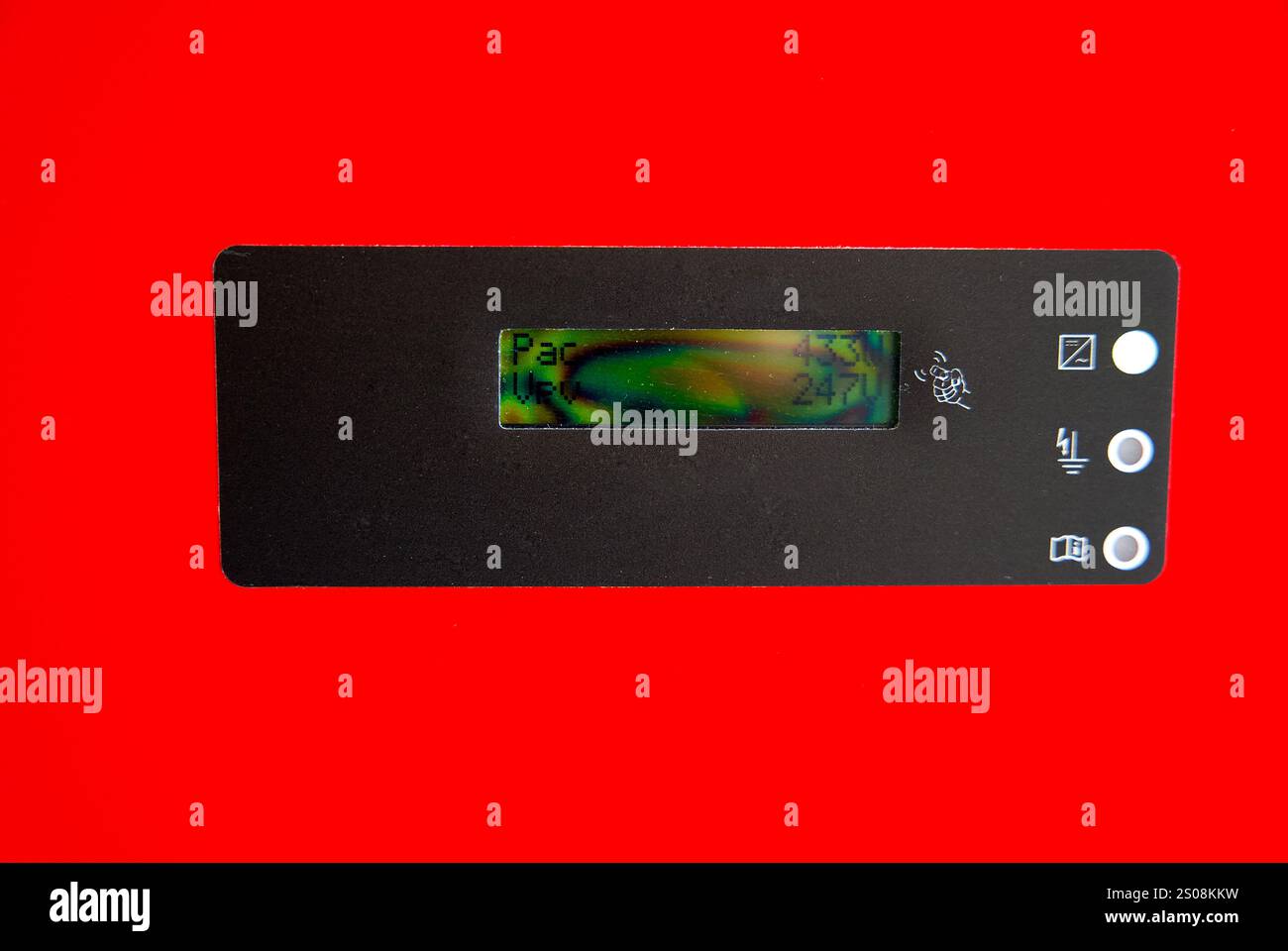 Close up of a red solar power inverter mounted to a white wall. Red ...