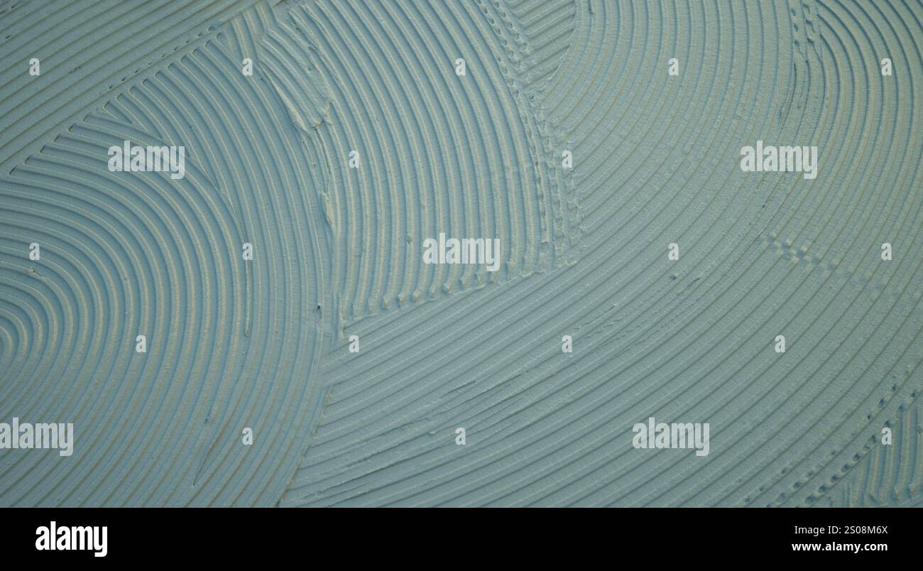 Texture cementitious adhesive applied to the floor ready to receive the ...