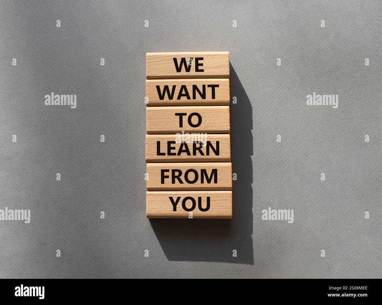 We want to learn from you symbol. Wooden blocks with words We want to ...