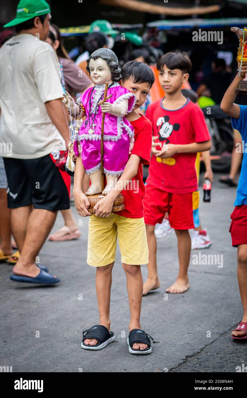 Filipino people celebrate an annual religious festival with a parade ...